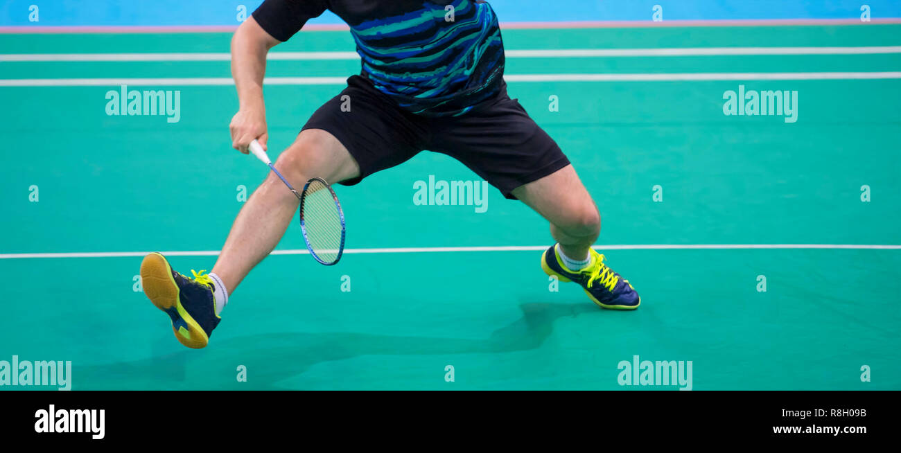 Badminton player beats the shuttlecock in the arena Stock Photo - Alamy