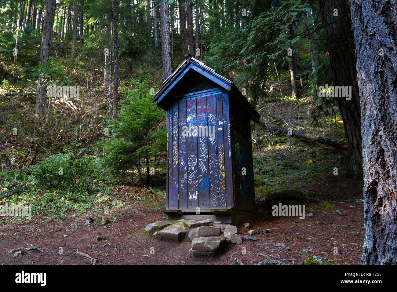 small structure housing a restroom known as an outhouse in the middle ...
