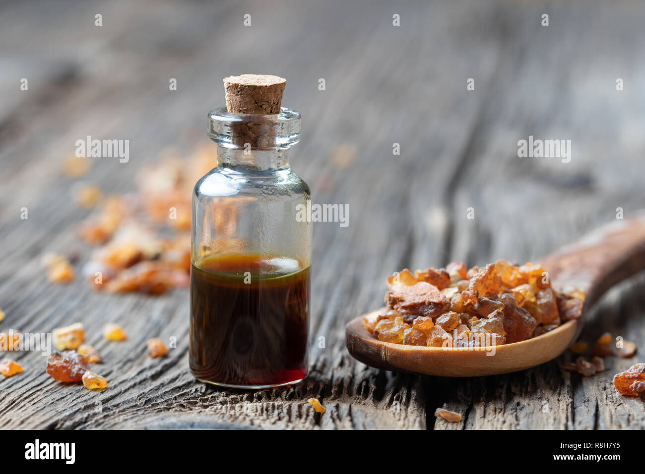 A bottle of essential oil with myrrh resin on a spoon Stock Photo - Alamy