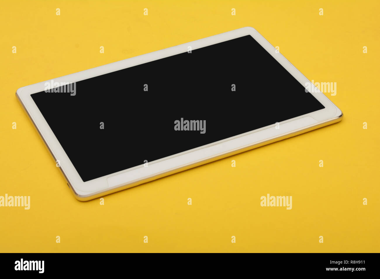Blank screen white tablet on yellow color background Stock Photo - Alamy