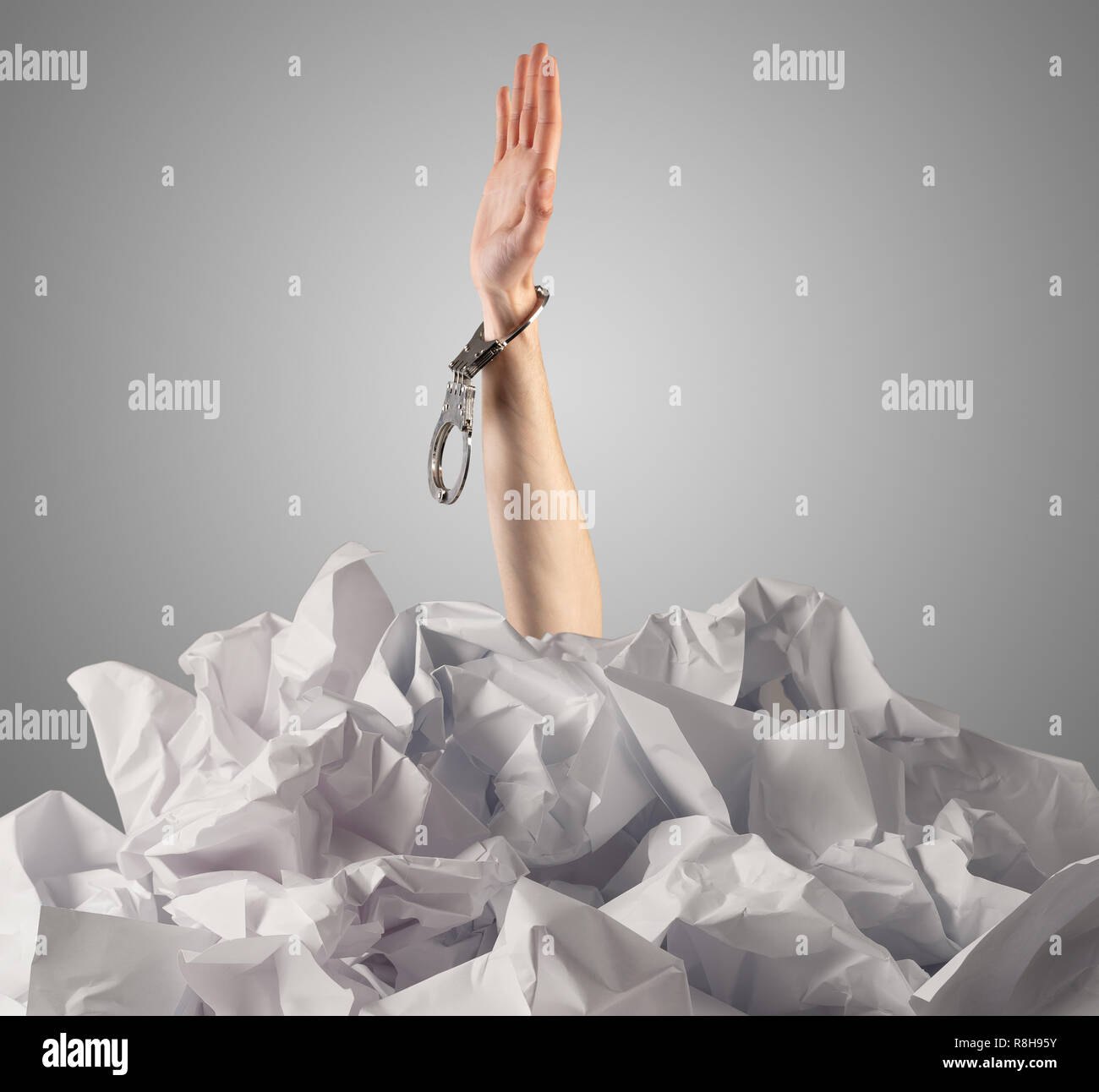 Hand breaking out from pile of paper Stock Photo - Alamy