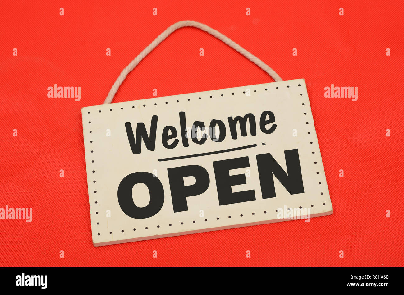 Welcome open sing sign on red background Stock Photo - Alamy