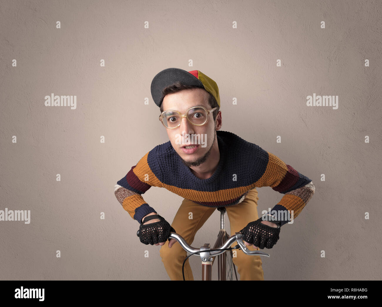 Nerd young foolish biker on a bike with oldschool outfit Stock Photo ...
