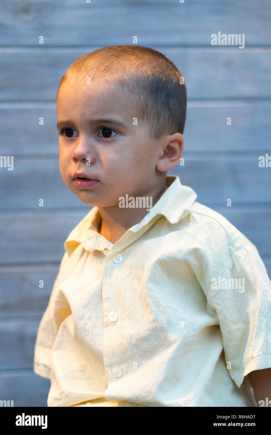 Beautiful little boy 2 years on a gray background. vertical photo Stock ...
