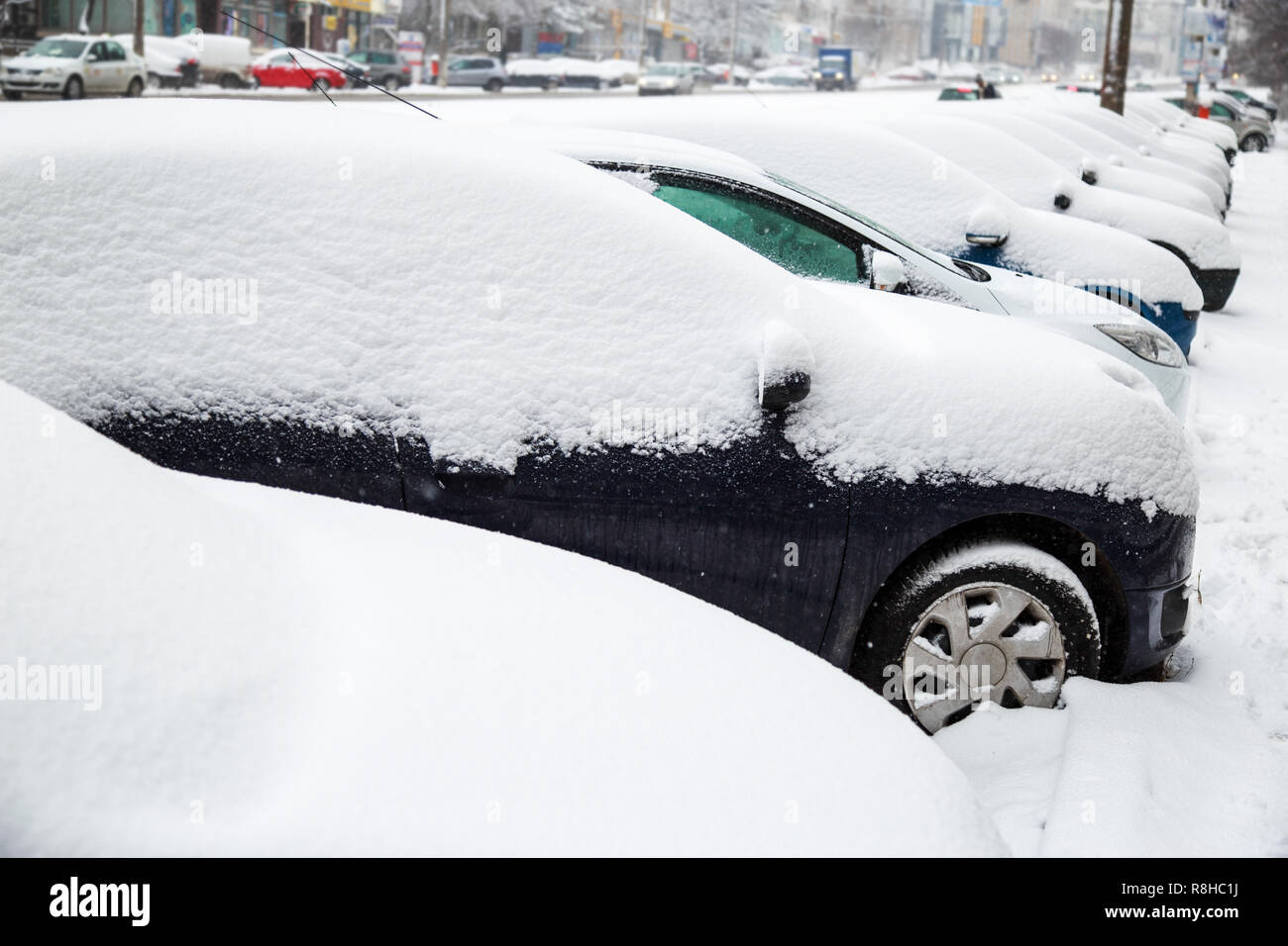 Snow covered cars. Many parked cars covered with snow after snowfall in ...