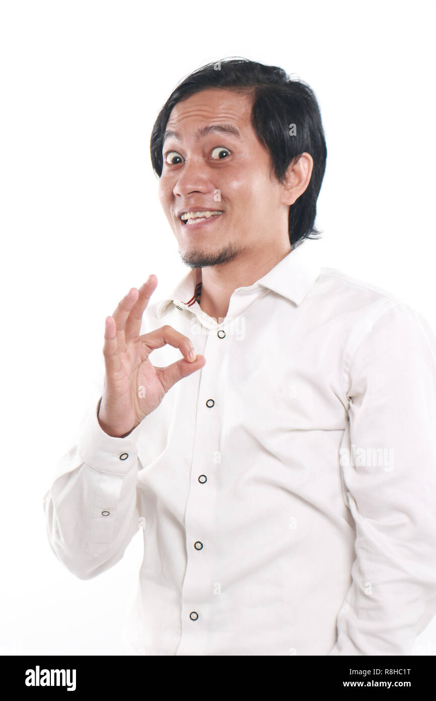 Photo image portrait of a cute funny young Asian man showing OK Sign ...