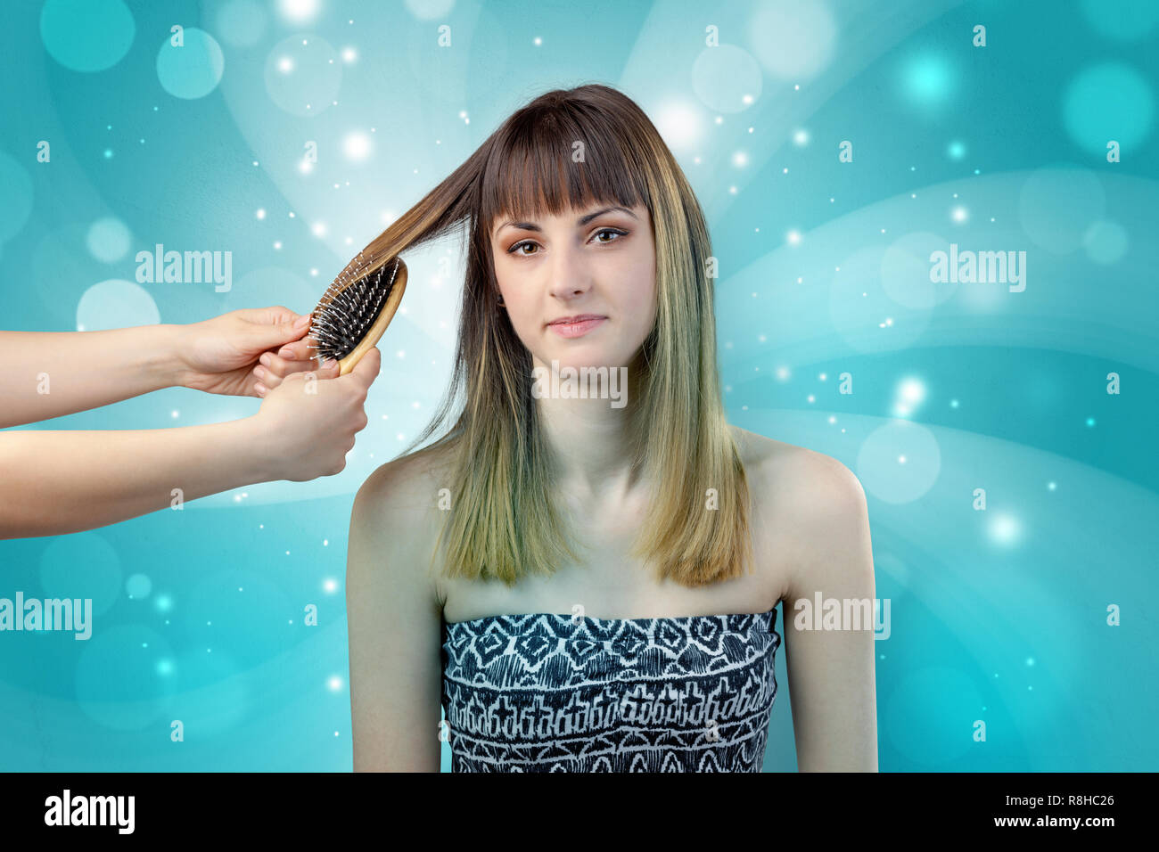 Graceful brunette woman getting ready with shiny turquoise wallpaper ...