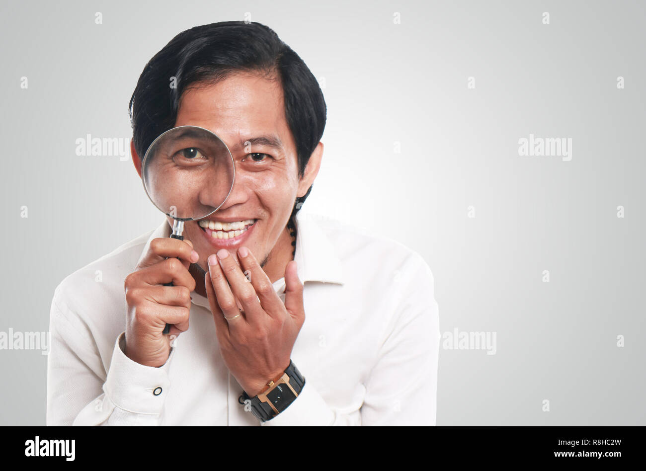 Adult holding magnifying glass hi-res stock photography and images - Alamy