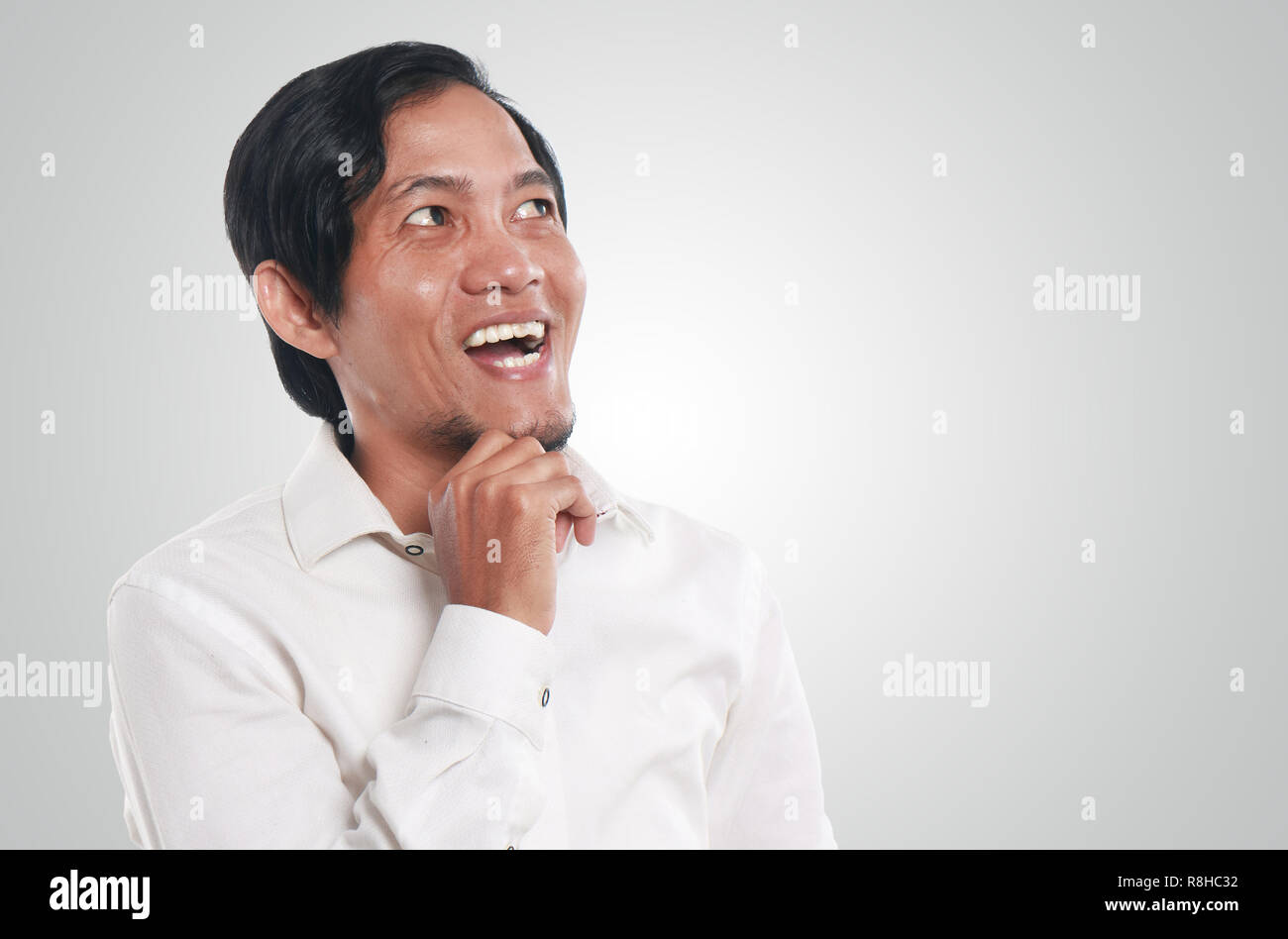 Photo image portrait of a funny young Asian businessman looking happy ...
