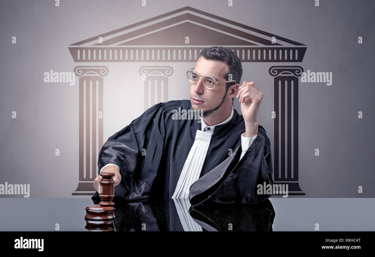 Young judge in front of a courthouse symbol making decision Stock Photo ...