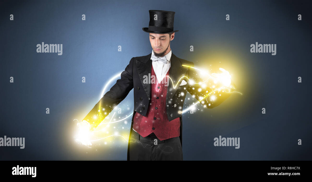 Magician holding his sparkling power between his two hand Stock Photo ...