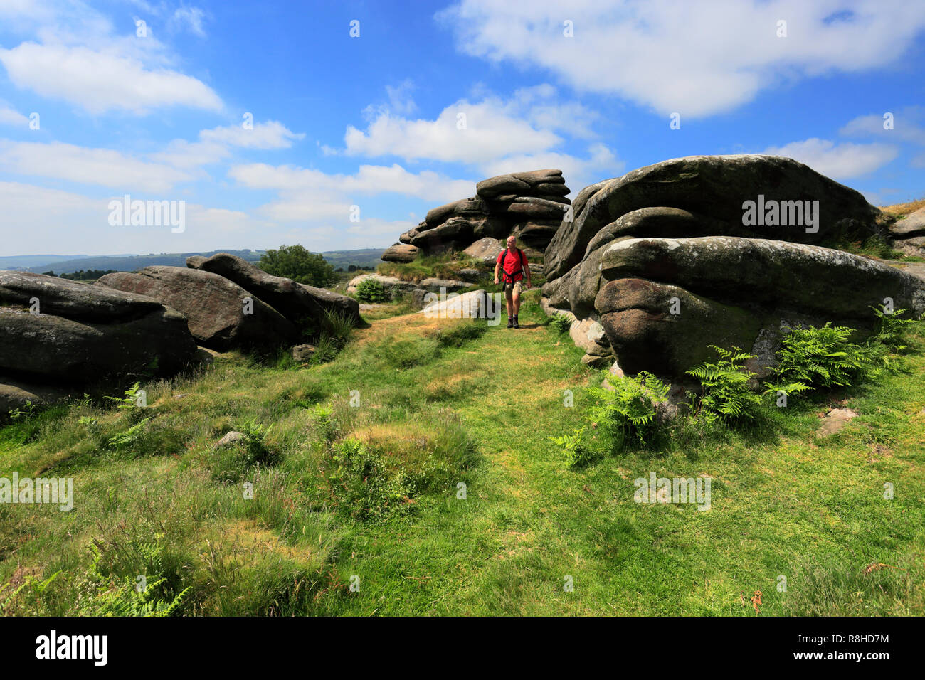 Walker at the Gritstone rock formations, Lawrence Field, Grindleford ...