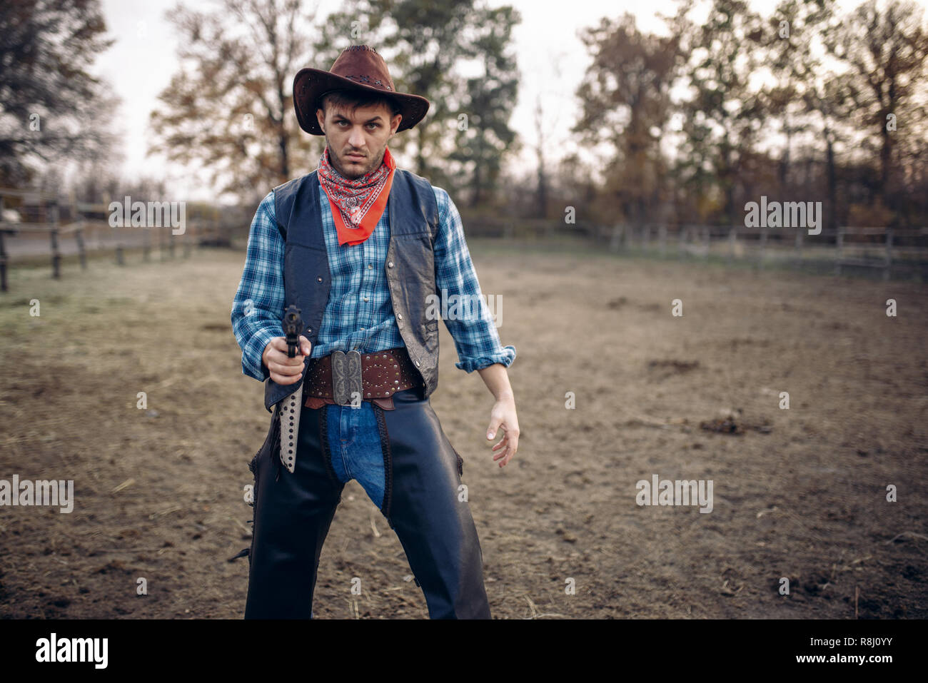 Cowboy with revolver makes quick shot, gunfight on texas ranch, western ...