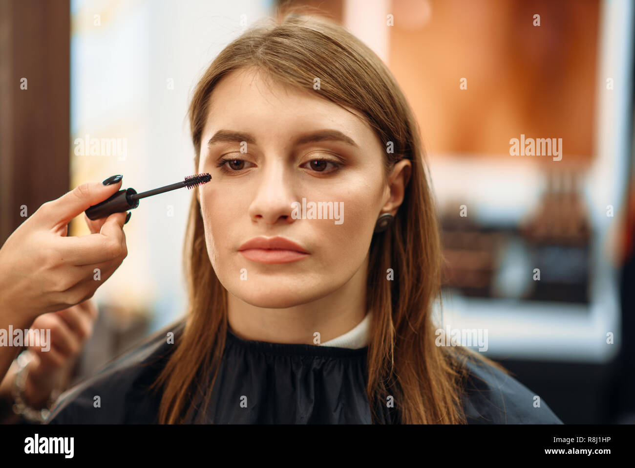 Cosmetician and female customer in makeup shop. Female client and ...
