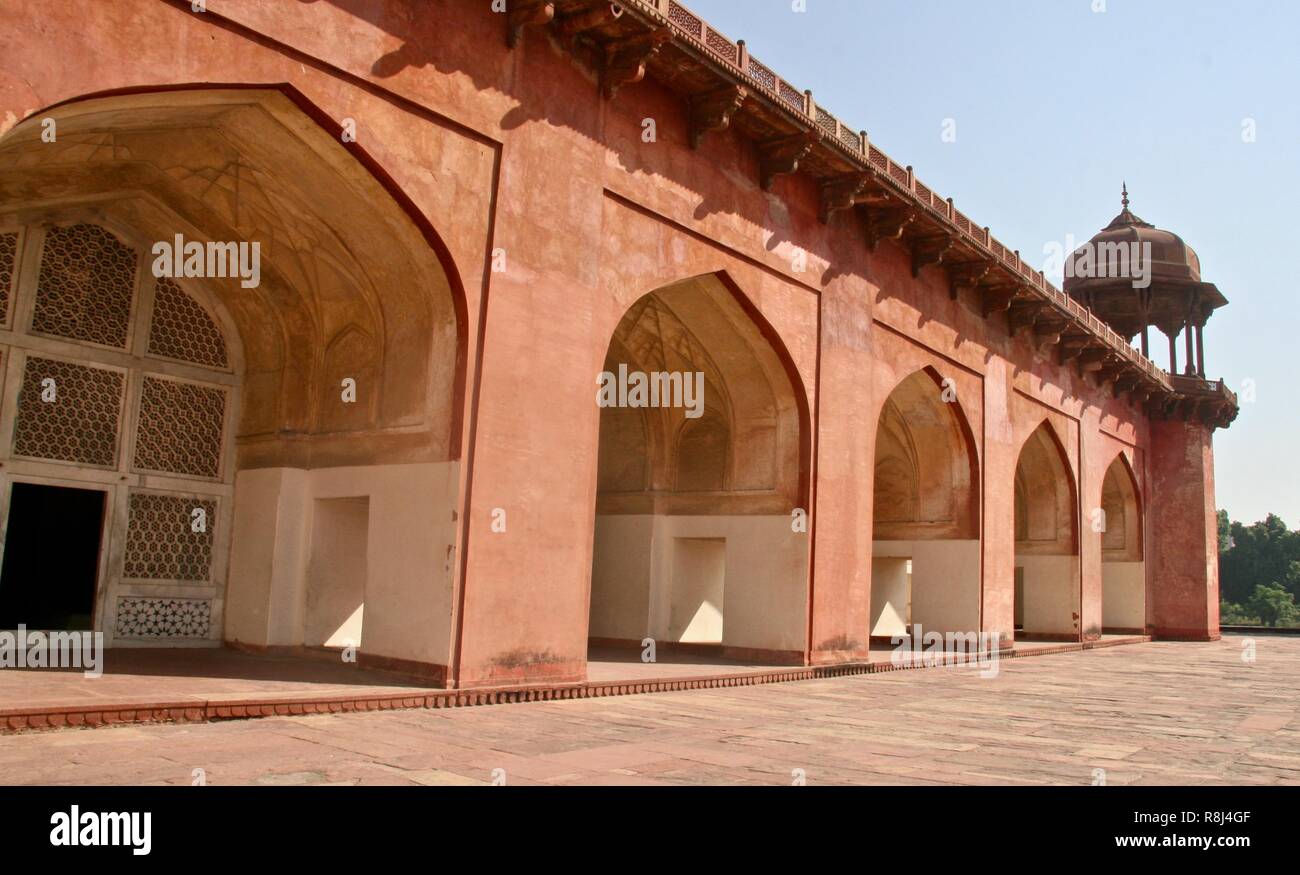 A line of red earthen toned arches in India showcasing their ...