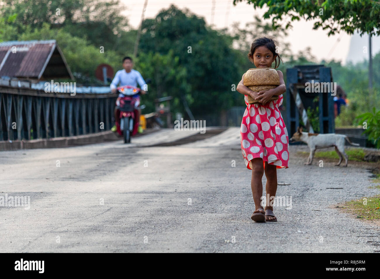 Thakhek, Laos - April 20, 2018: Ethnic minority child walking on a road ...