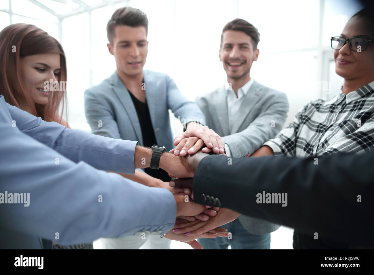 Business people joining hands in circle Stock Photo - Alamy