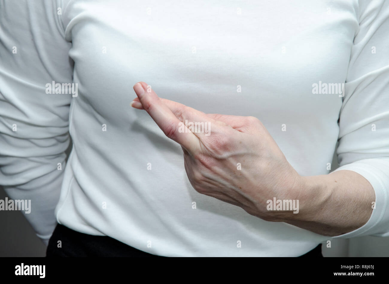 hand with cross fingers gesture on white background Stock Photo - Alamy