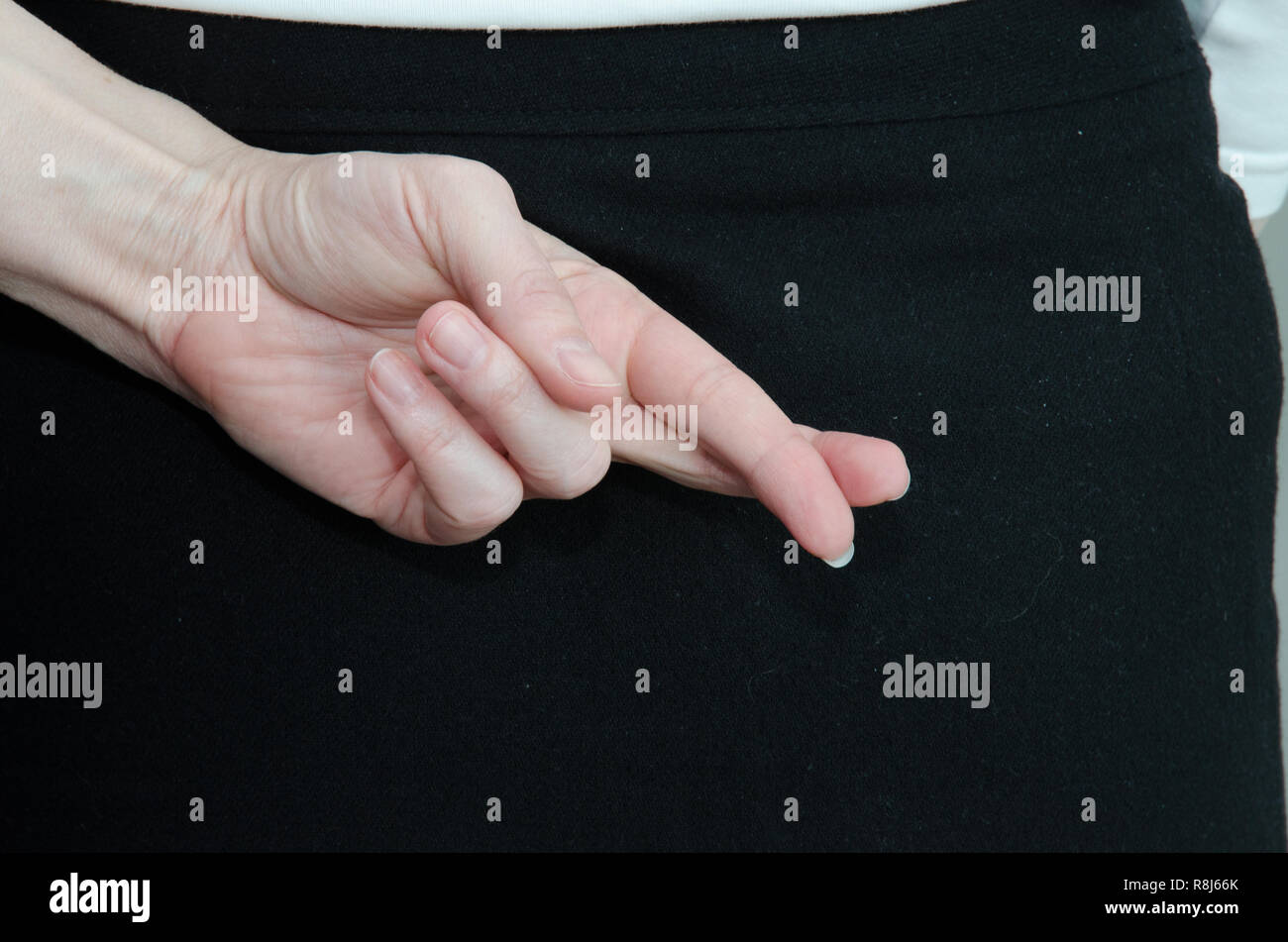 hand with cross fingers gesture on white background Stock Photo - Alamy