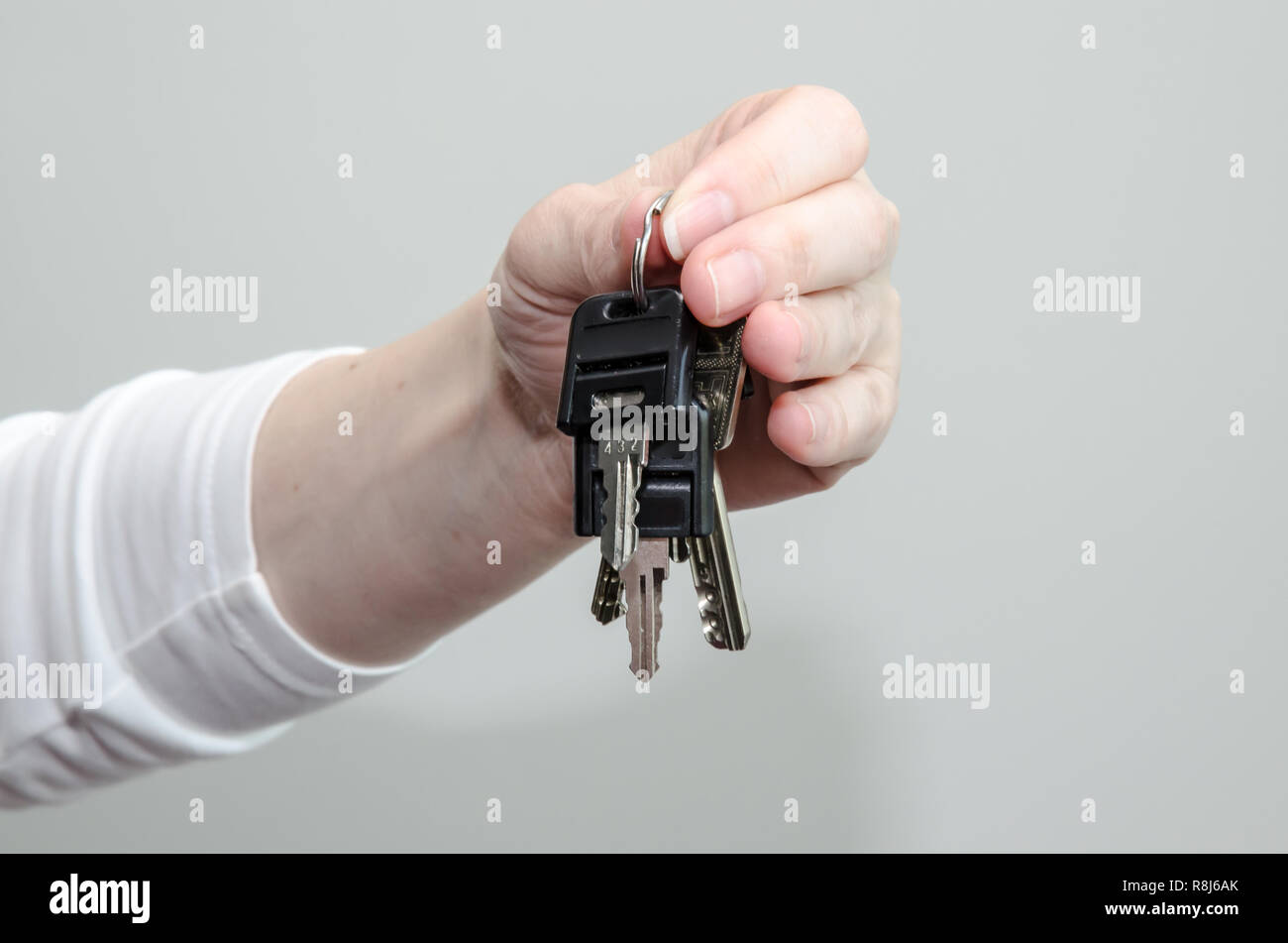 hand with keys on white background Stock Photo - Alamy