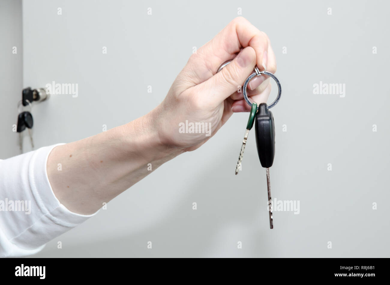 hand with keys on white background Stock Photo - Alamy