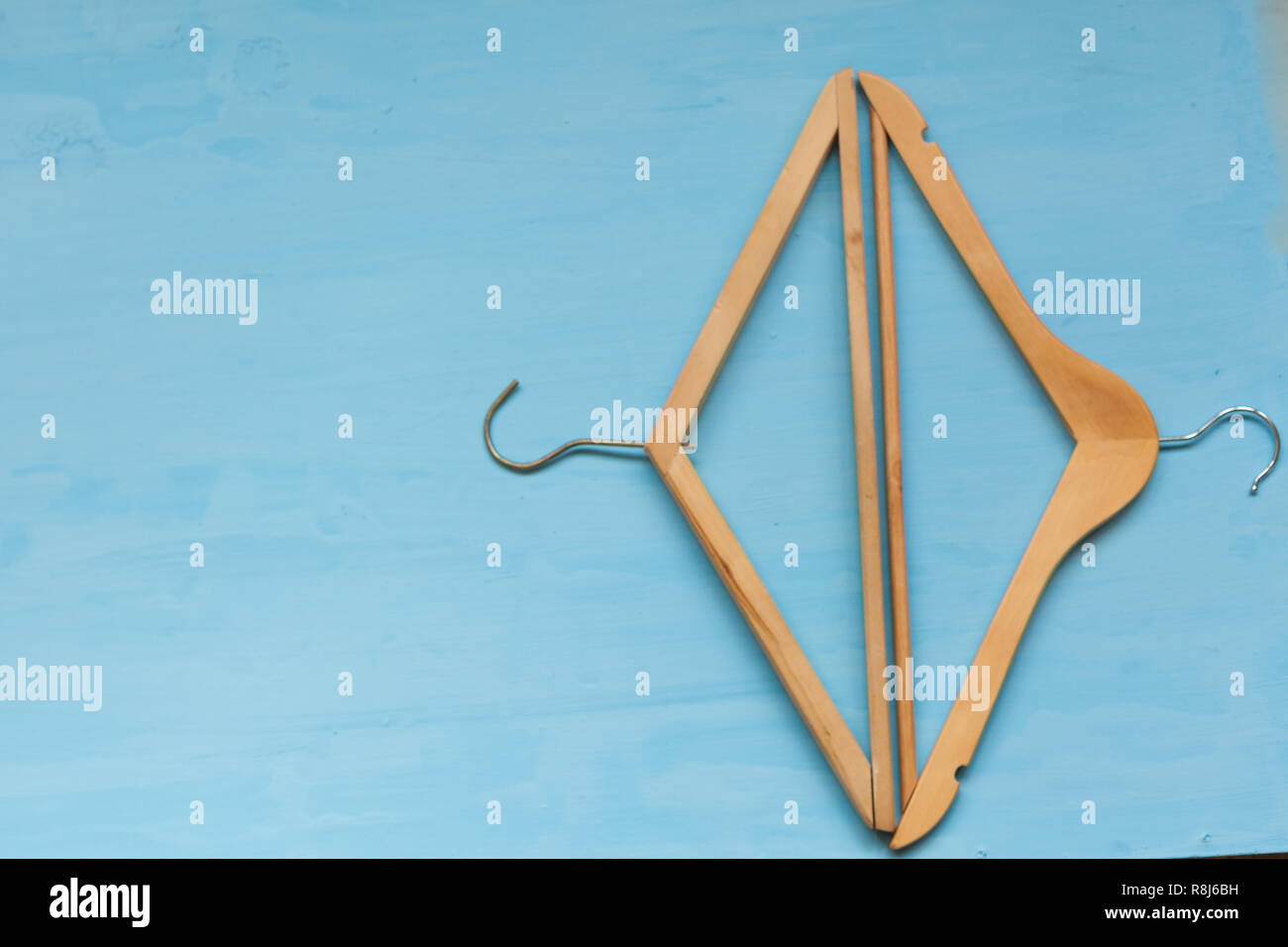 old wooden hangers for things on the table background Stock Photo - Alamy