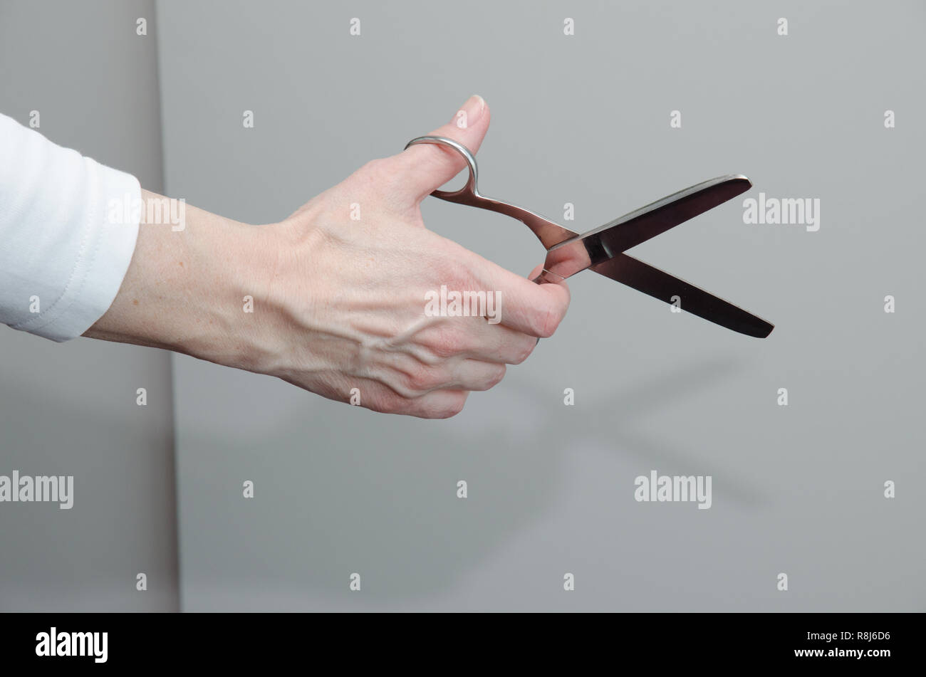 hand with scissors on white background Stock Photo - Alamy