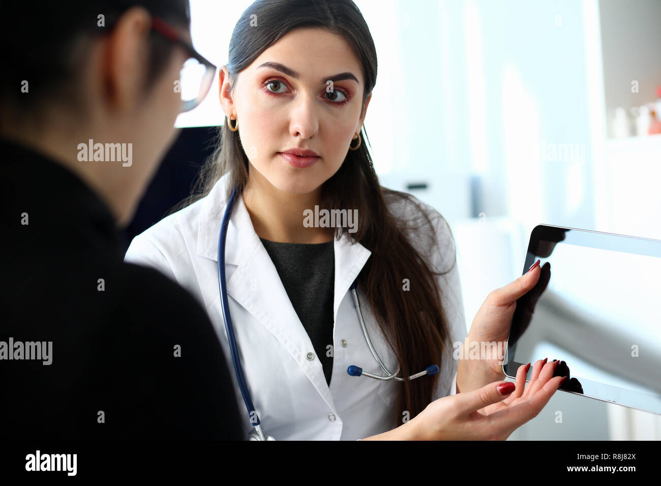 Beautiful female medicine doctor explain Stock Photo - Alamy