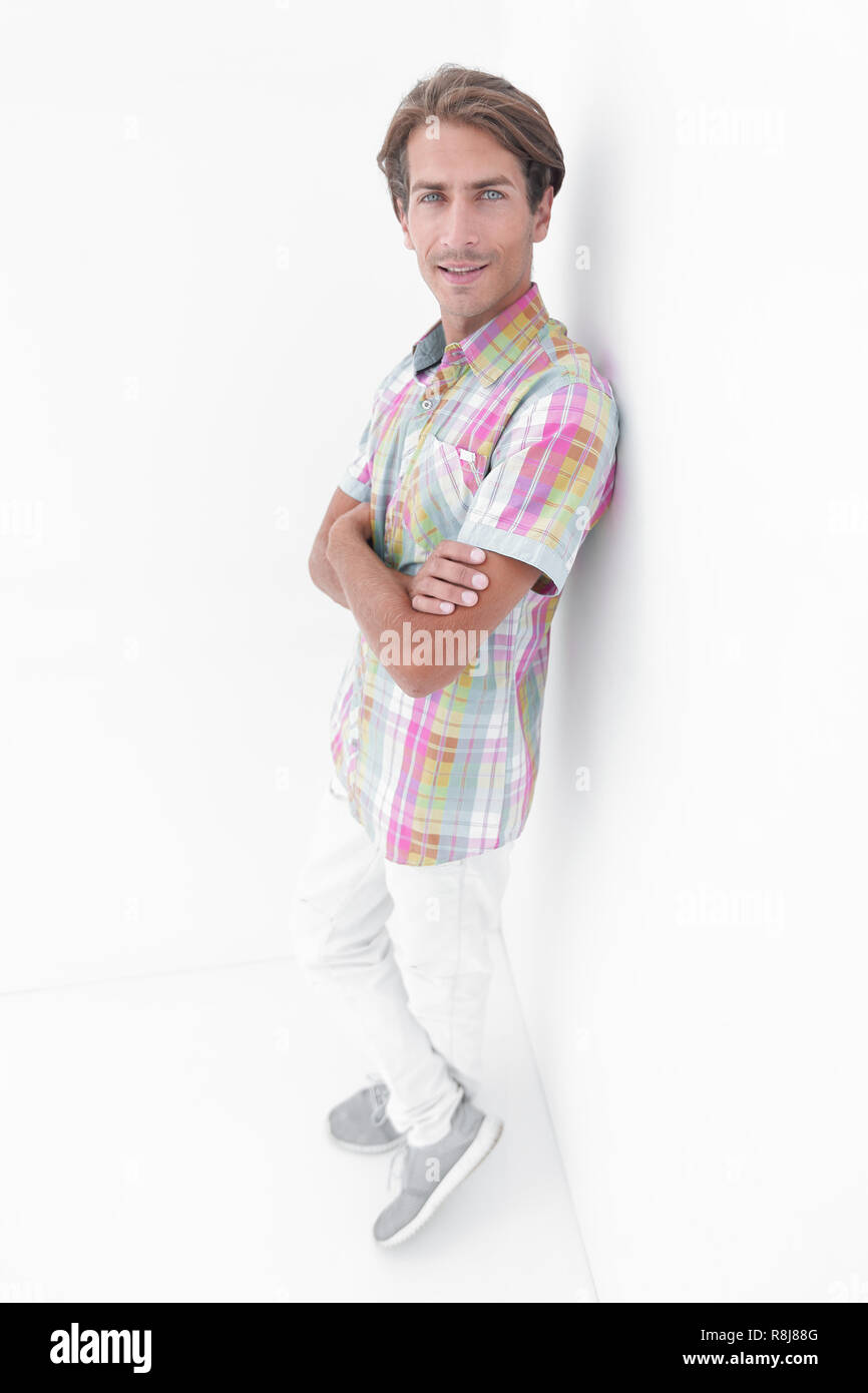 serious young man leaning on wall Stock Photo - Alamy
