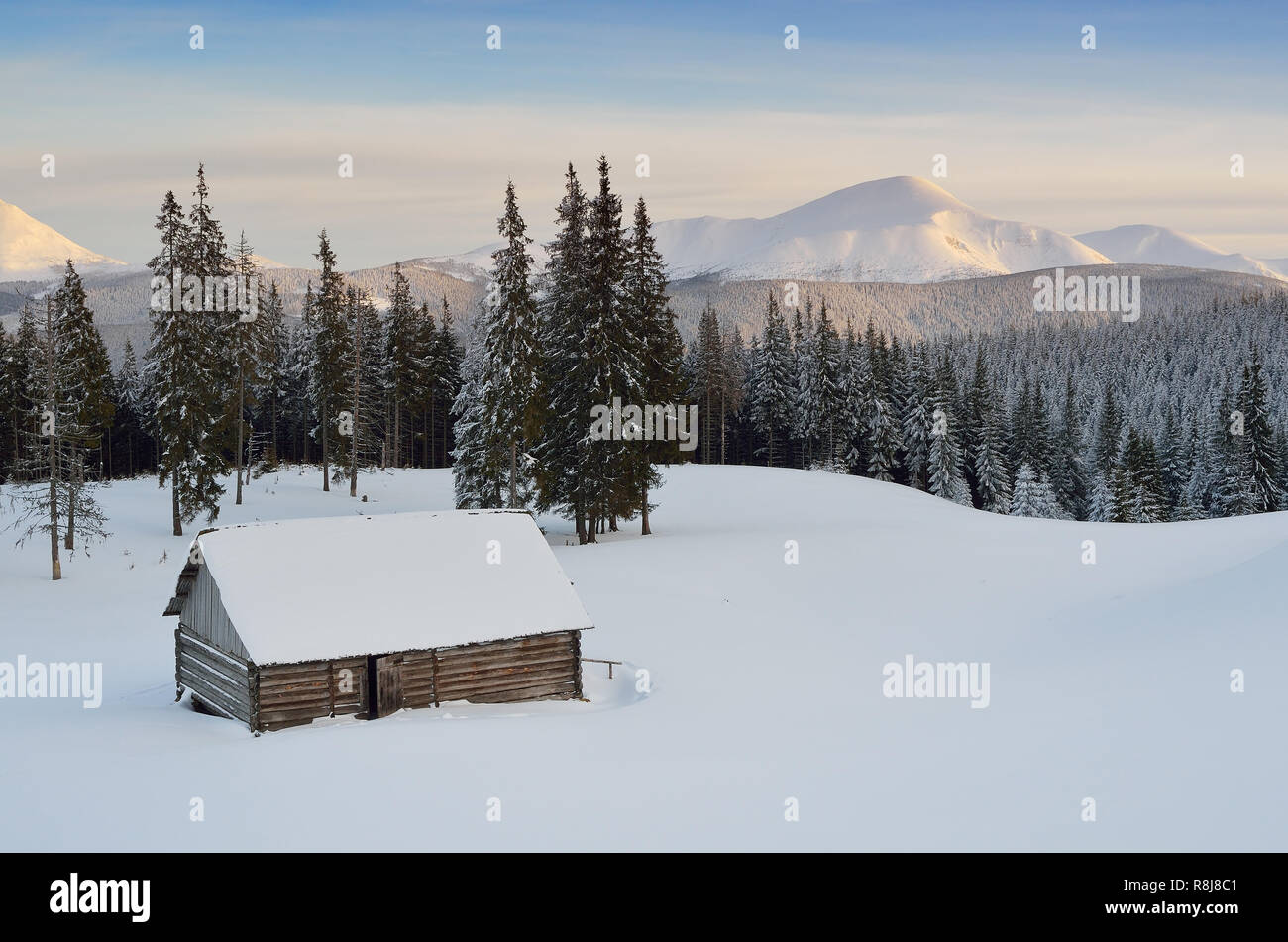 Winter in the mountain valley. Snowy Landscape with hut and mountain ...