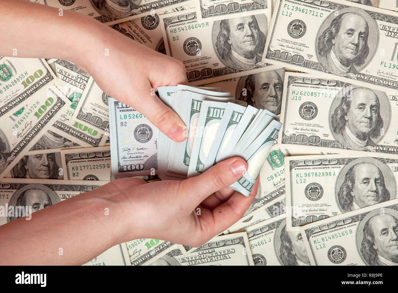 Cash in hand. Profit, savings. Stack of dollars. a person who is ...