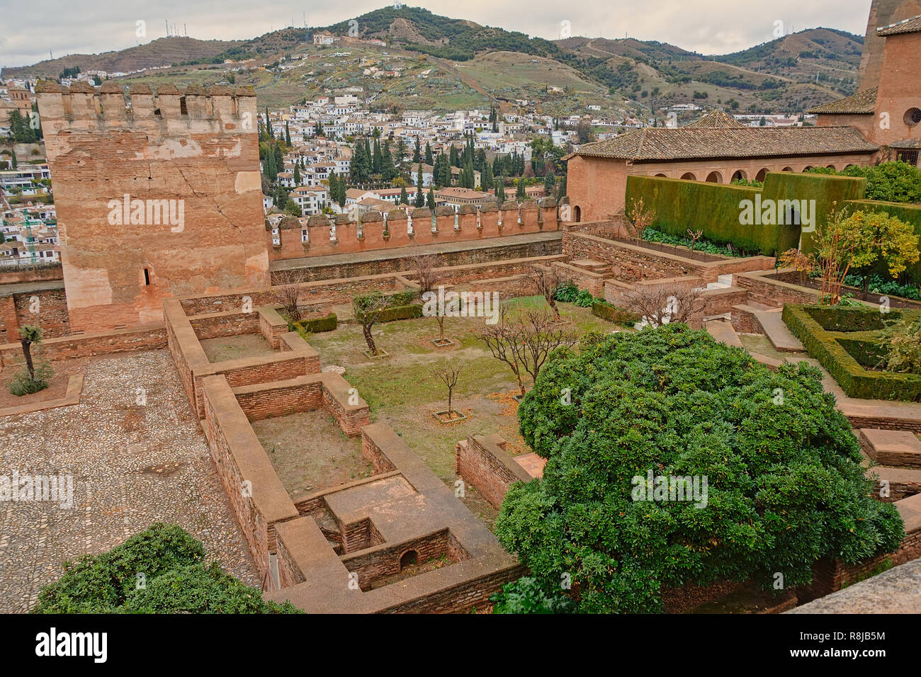 Patio and walls of Alhambra medieval moorish castle, with hills of ...