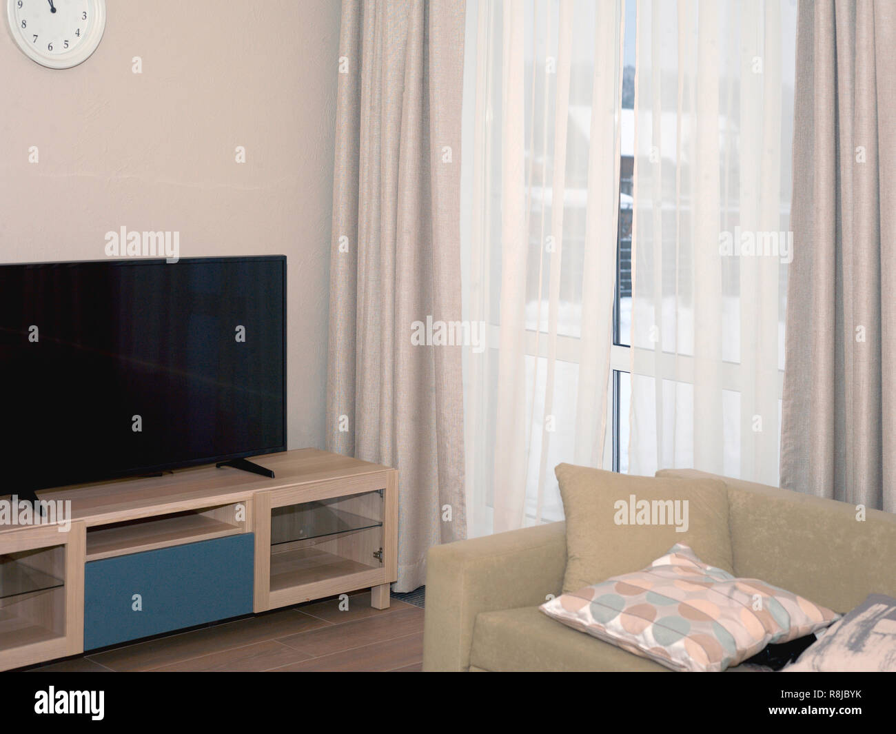 TV set and sofa in a modern living room, interior shot Stock Photo - Alamy