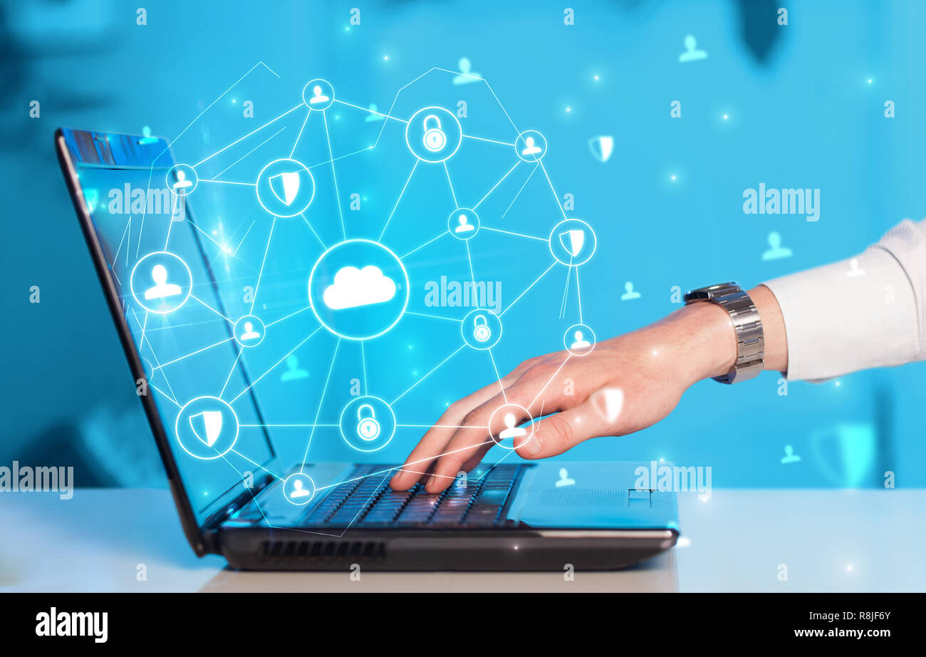 Hand using laptop with centralized cloud computing system and network ...