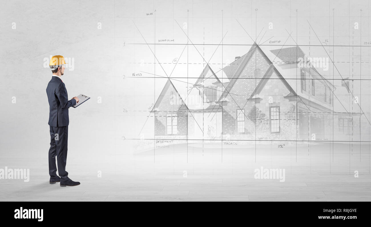 Architect standing and watching an imagined house plan Stock Photo - Alamy