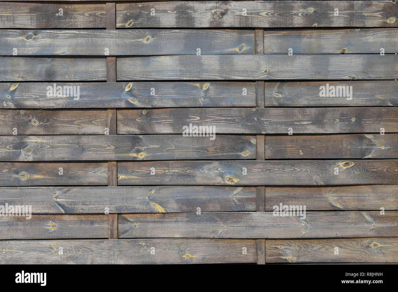 Texture of an old rustic wooden fence made of flat processed boards ...