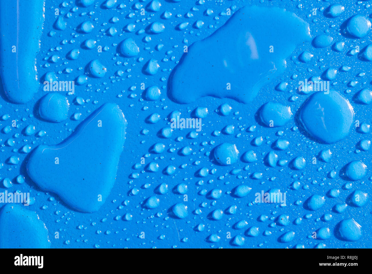 Multiple water drops raindrops on light blue background Stock Photo - Alamy
