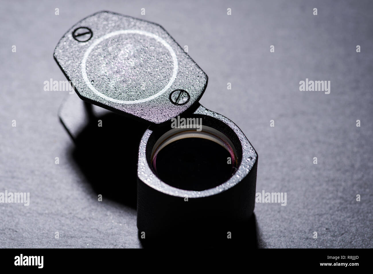 Loupe, magnifying glass on natural stone background Stock Photo - Alamy