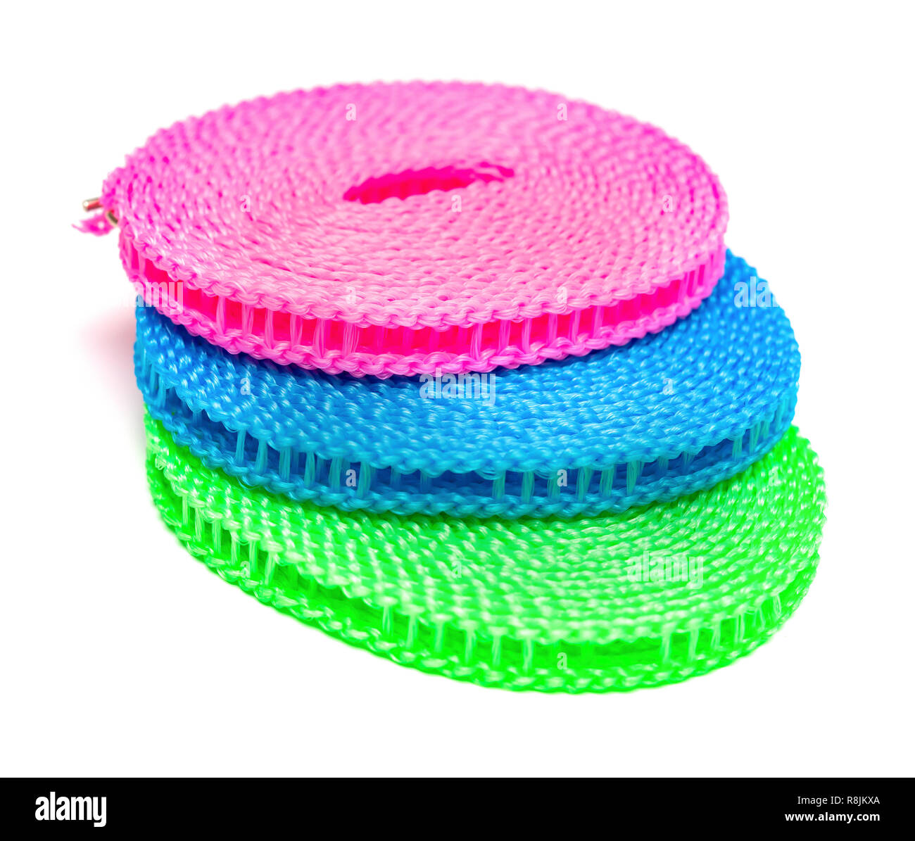 blue red and green plastic clotheslines stacked up on white Stock Photo ...