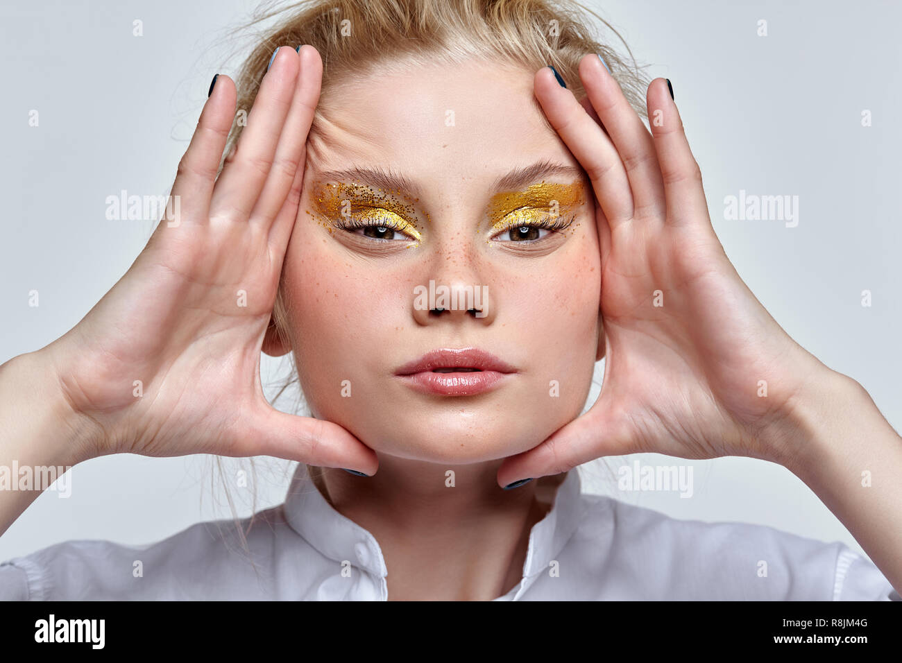 Emotional portrait of a young blonde woman on gray background. Female ...