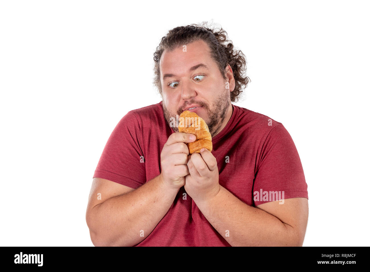 Funny fat man eating croissant Stock Photo - Alamy