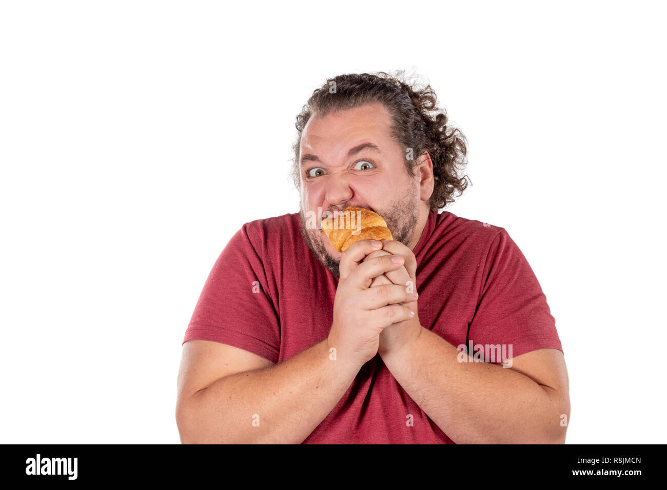 Funny fat man eating croissant Stock Photo - Alamy