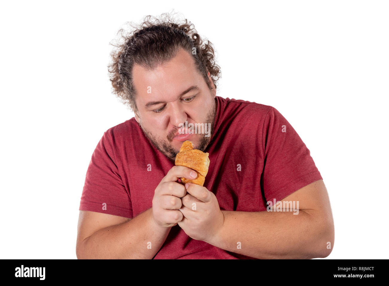 Funny fat man eating croissant Stock Photo - Alamy