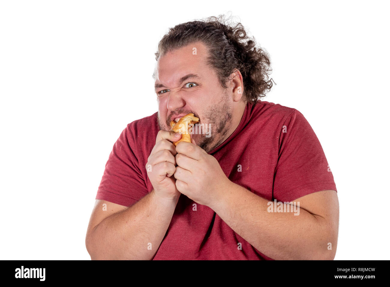 Funny fat man eating croissant Stock Photo - Alamy