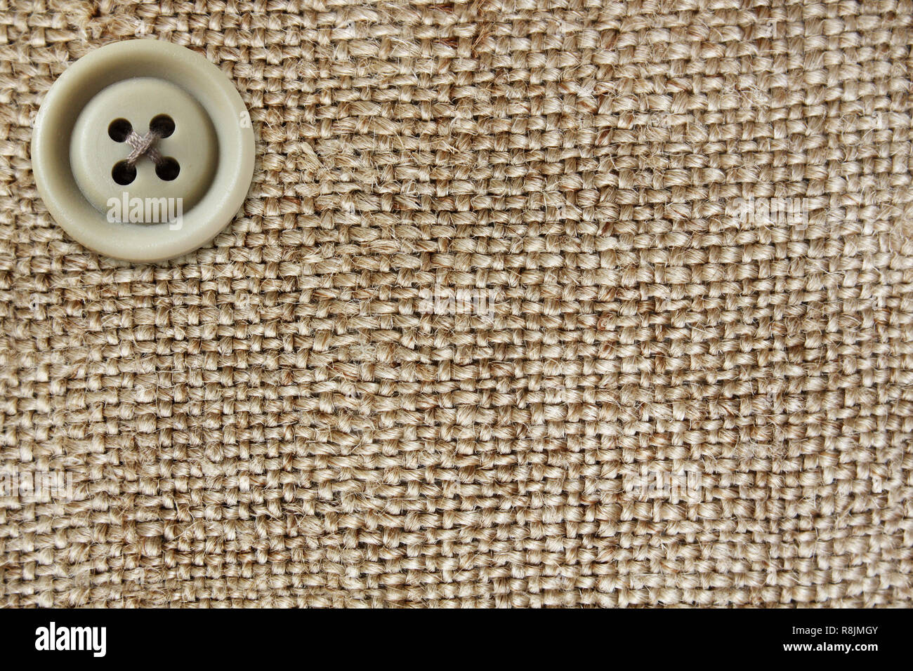 Background with bagging texture and button Stock Photo - Alamy