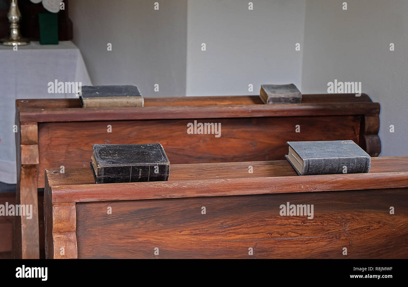 4 old prayer books in small chapel Stock Photo - Alamy