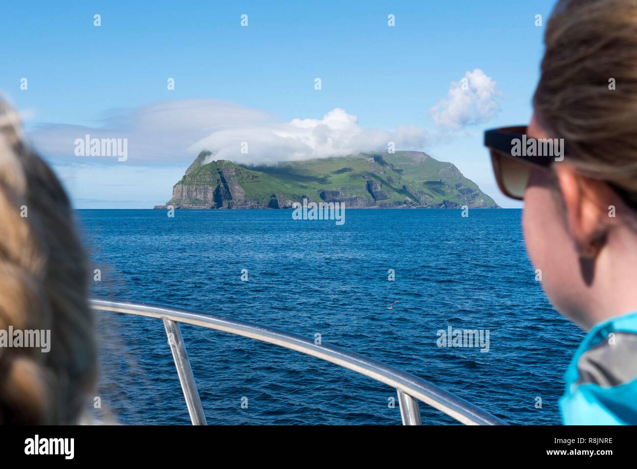 Denmark, Faroe Islands, Mykines Island, tourists boat heading towards ...