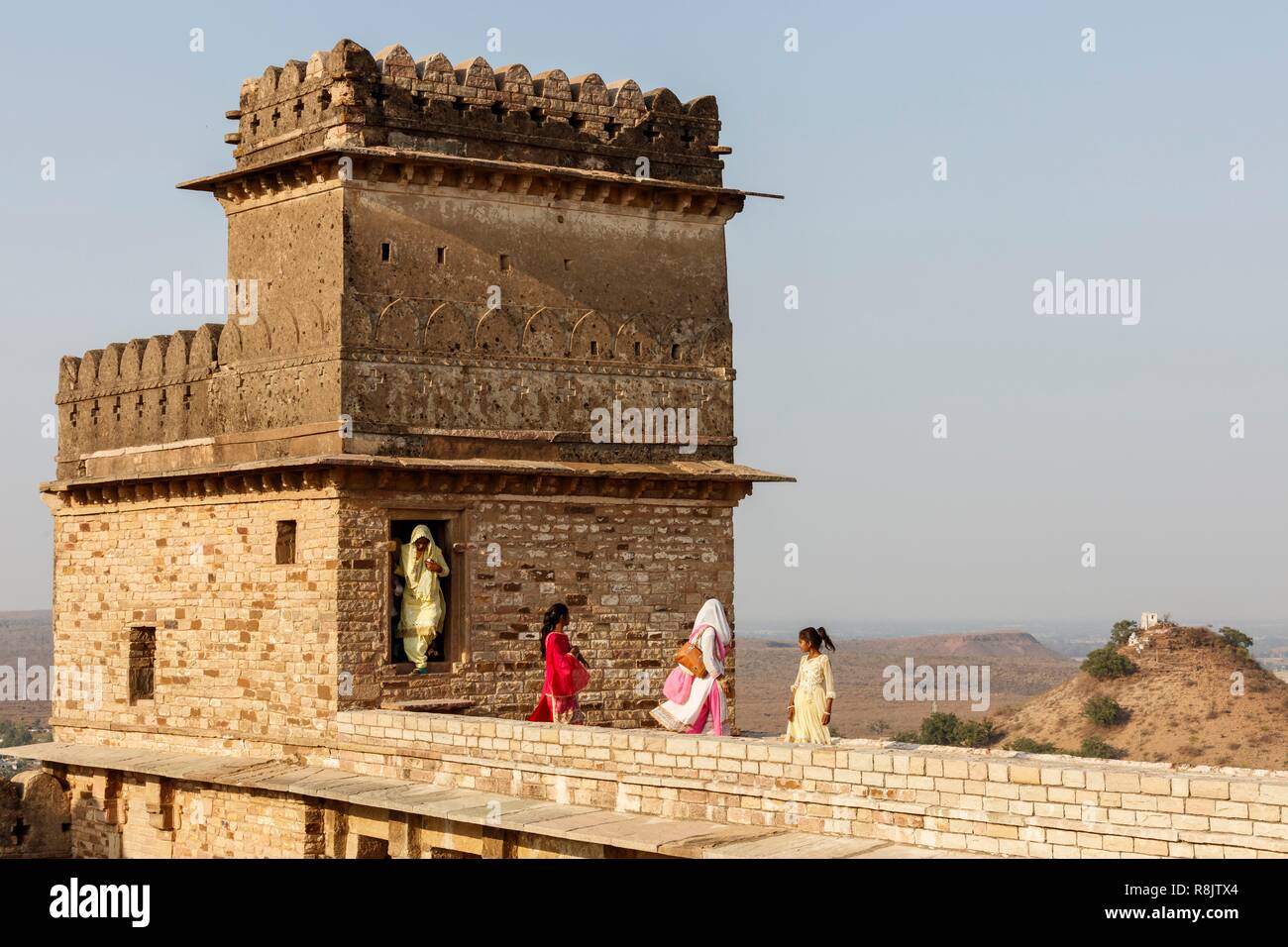 India, Madhya Pradesh, Chanderi, four women on Chanderi Fort ramparts ...