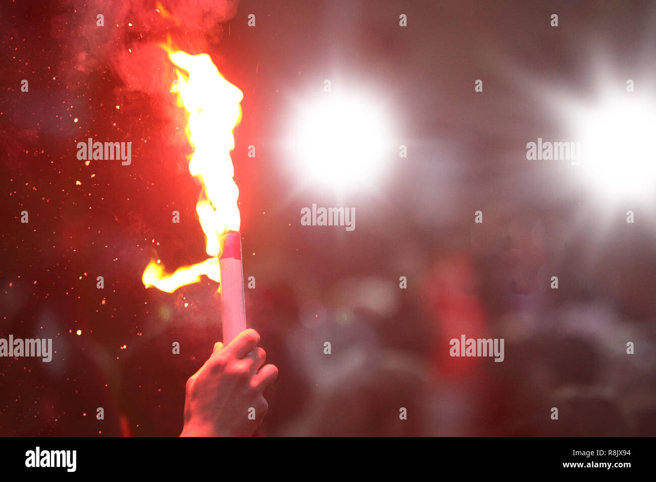 A hand holding a burning hand flare Stock Photo - Alamy
