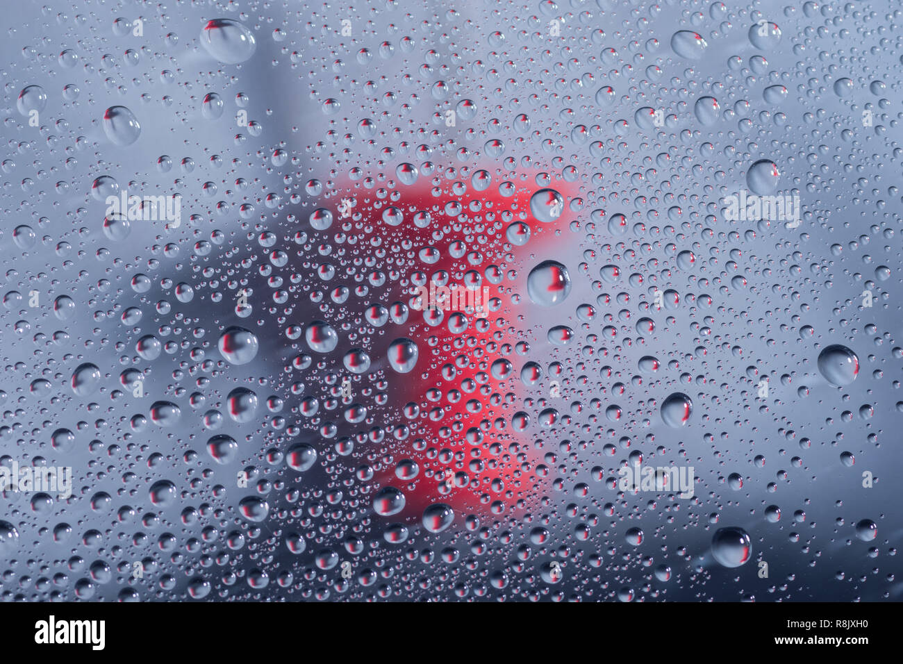 Water drops, rain drops or droplets on glass with push pins in the ...